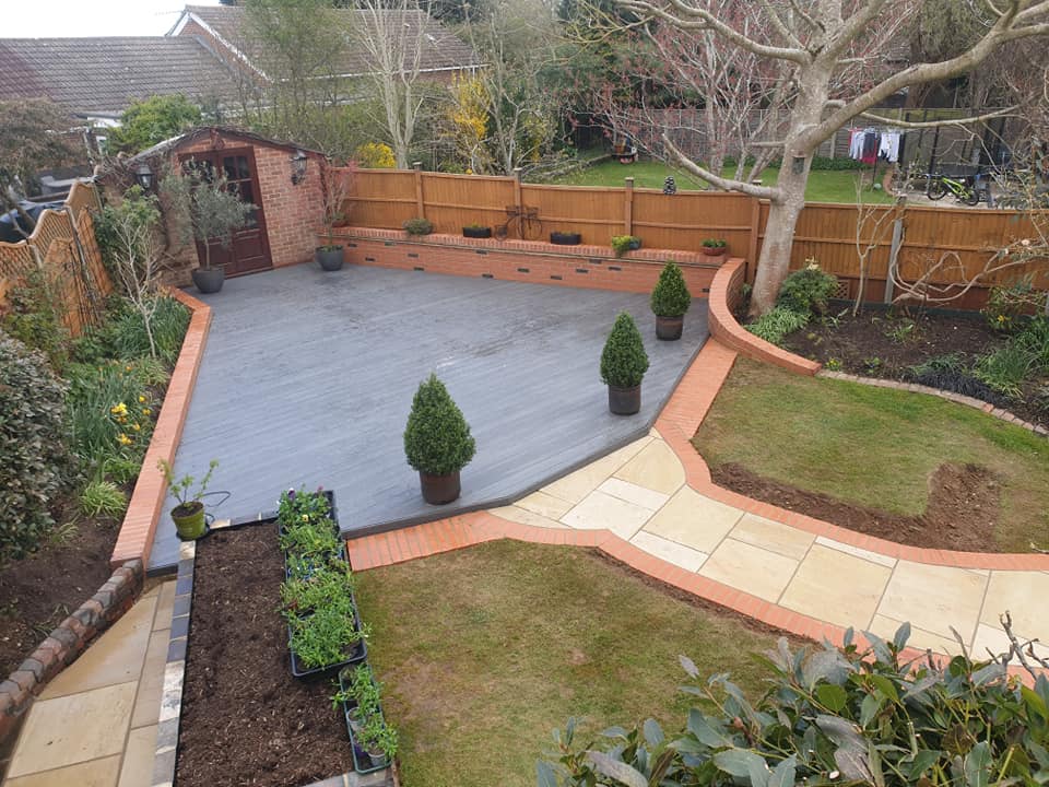 Composite decking surrounded by brick walls and path, Thame | Baker ...